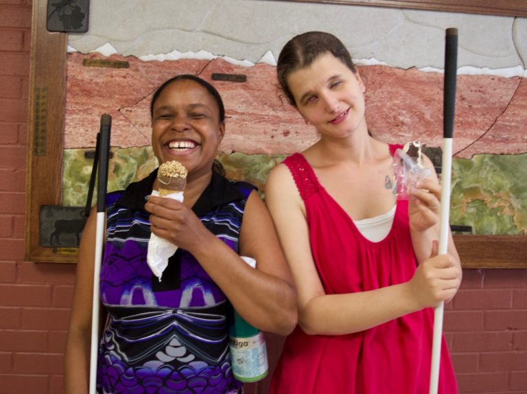 Image: Mo and Jen standing in front of the mural enjoying ice cream ...